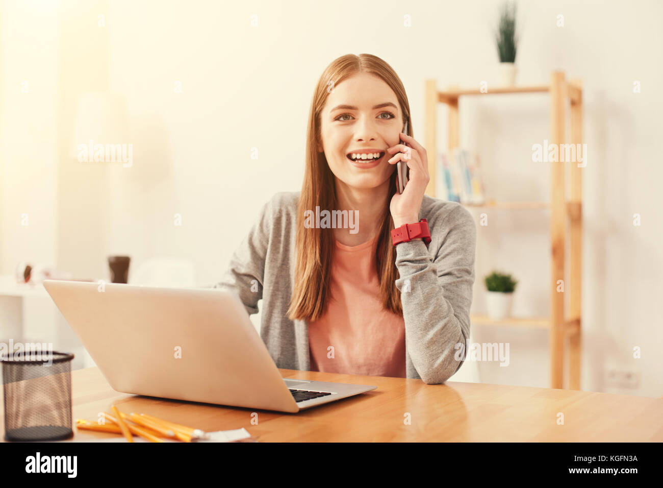 Cute student smiling while speaking on the phone Stock Photo - Alamy