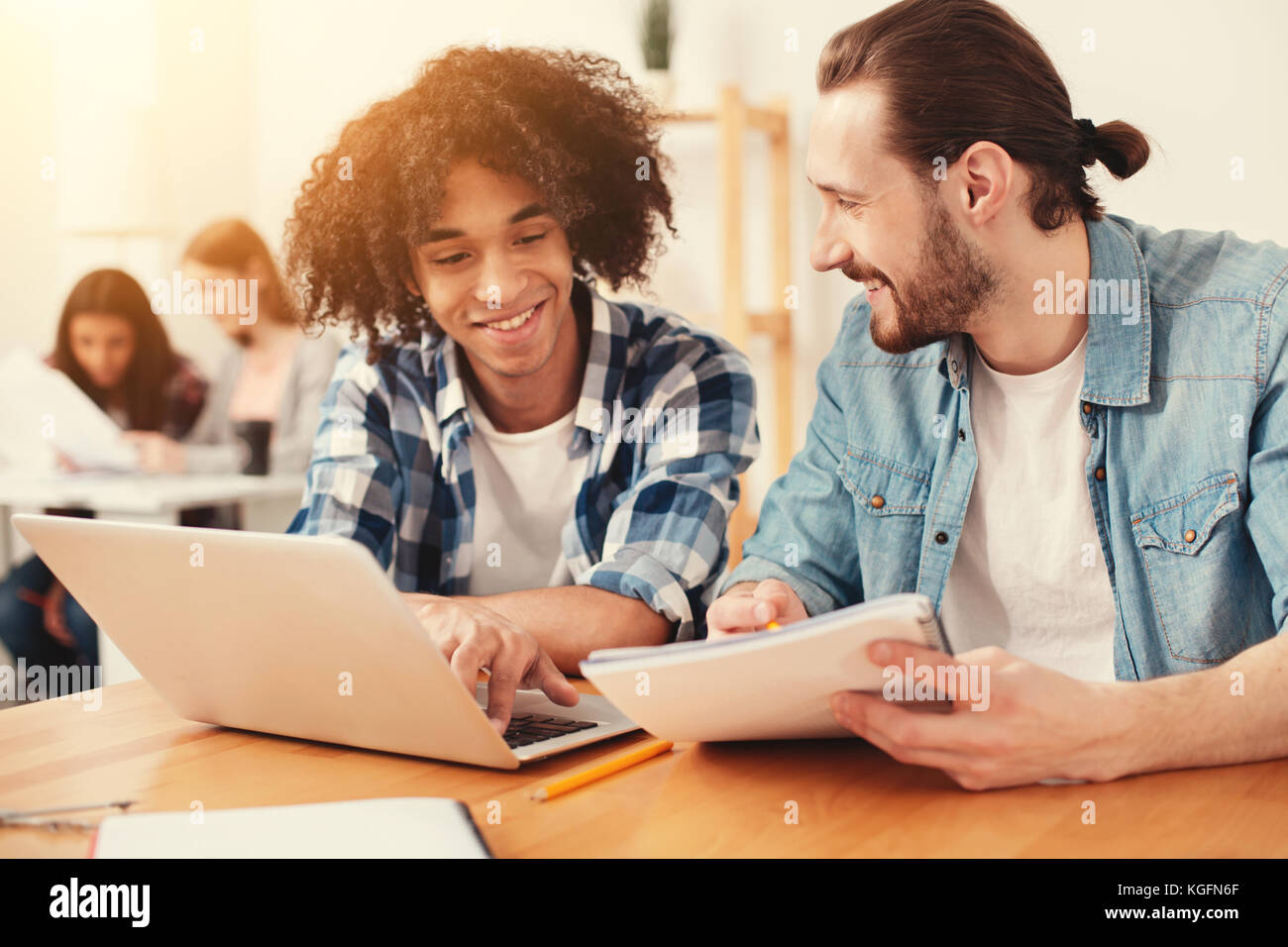 Good friends smiling while reading their notes Stock Photo - Alamy