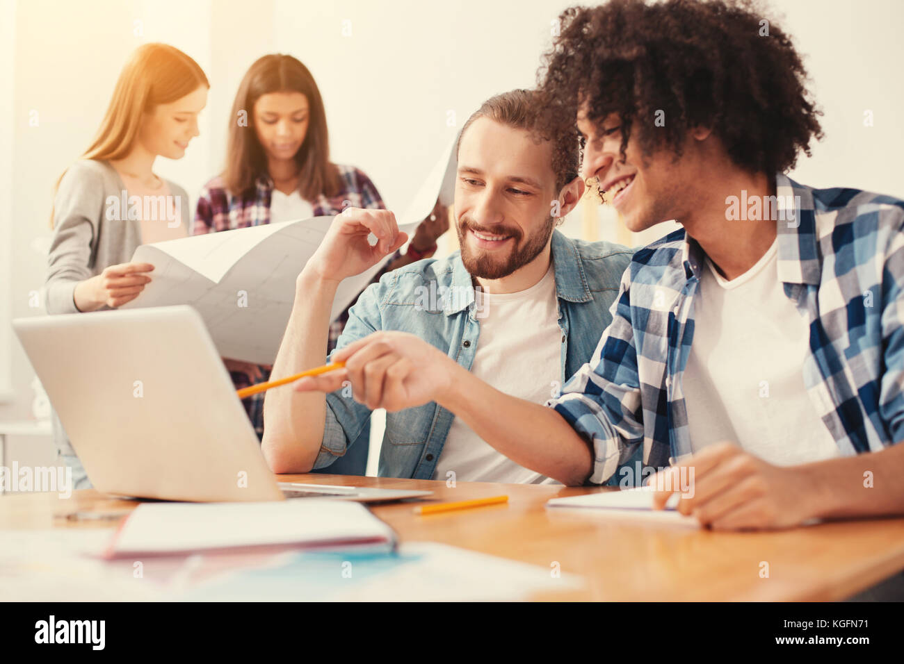 Smiling man pointing at the screen with his pencil Stock Photo - Alamy