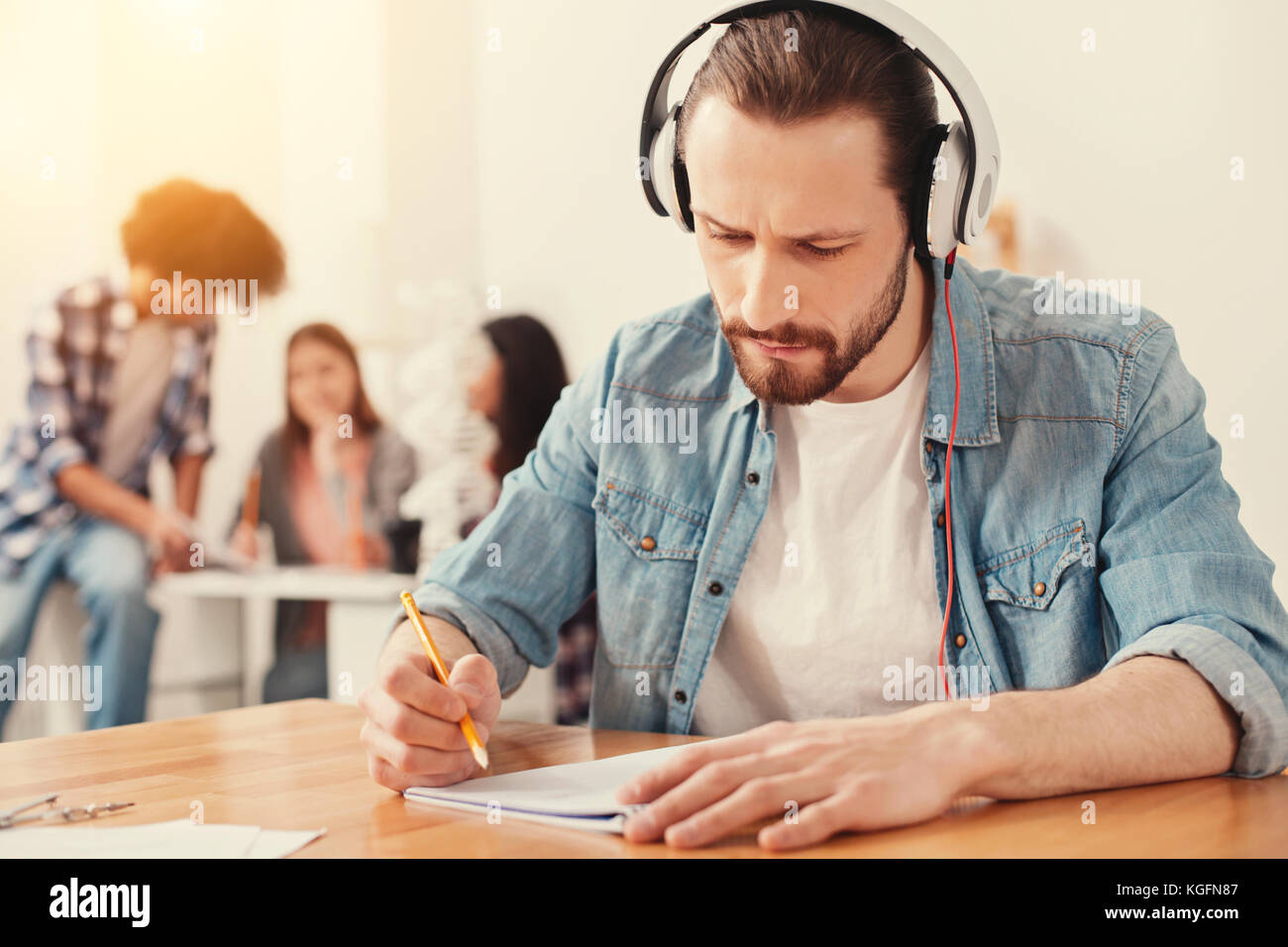 Concentrated bearded man writing a test Stock Photo - Alamy