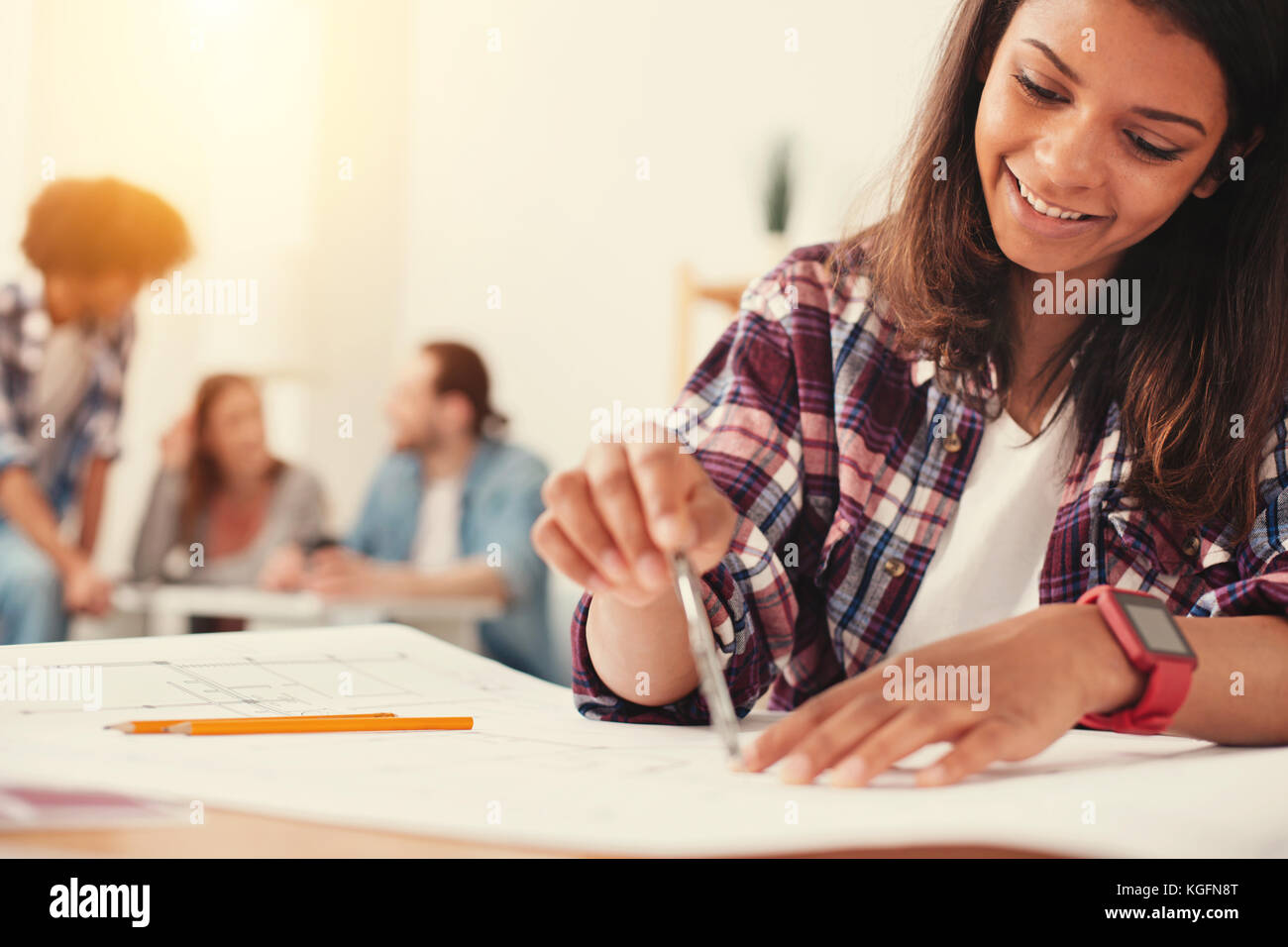 Smiling student measuring the distance on her graphic Stock Photo - Alamy