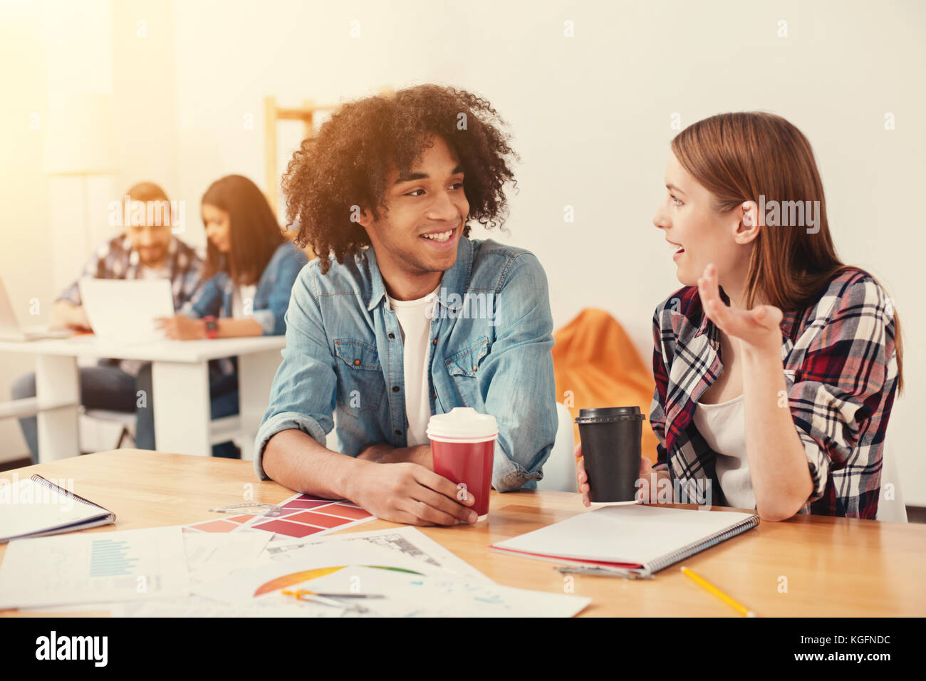 Happy students communicating while drinking coffee Stock Photo - Alamy