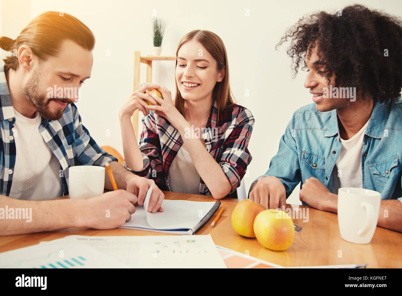 Bearded man making notes while sitting with his friends Stock Photo - Alamy