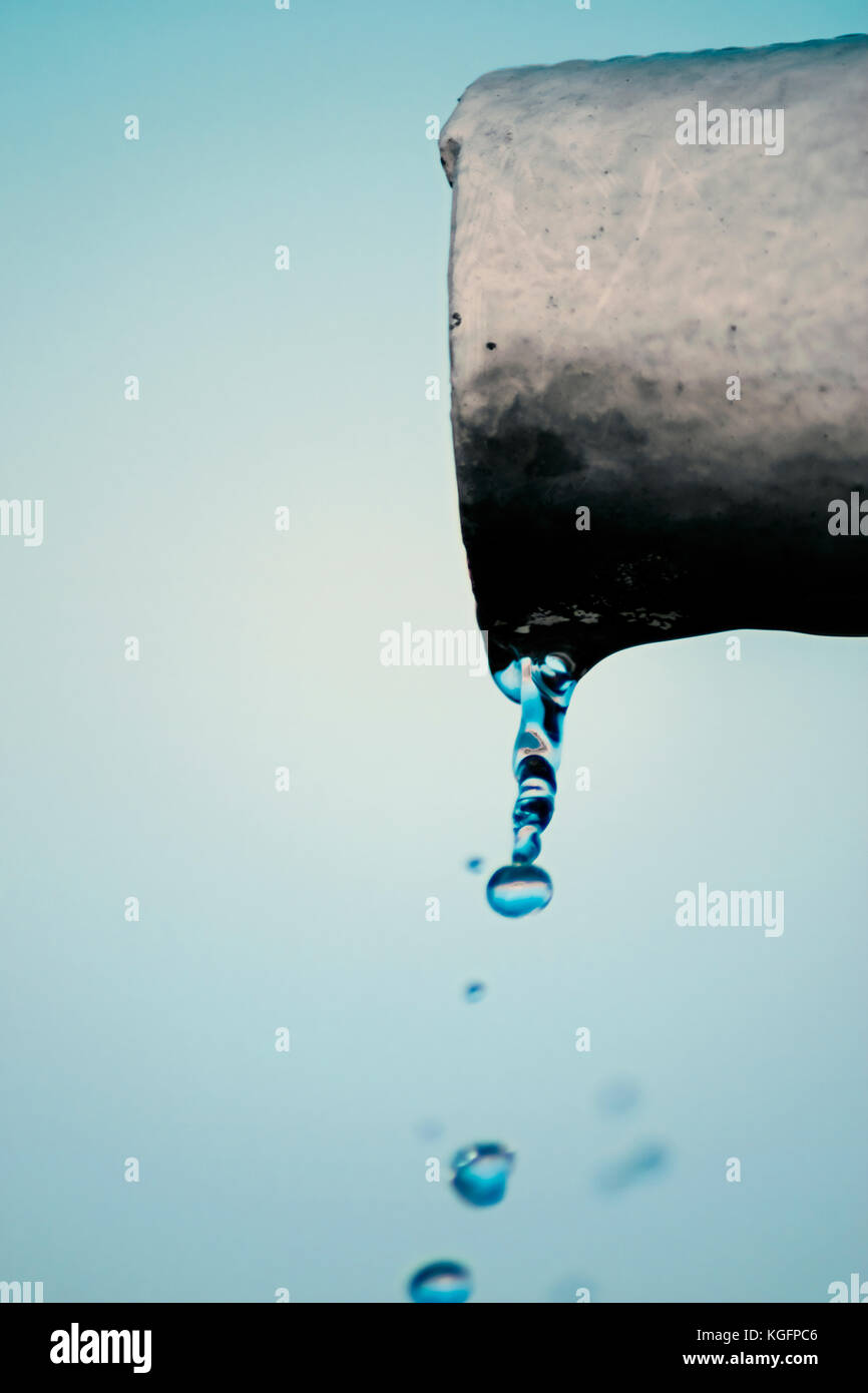 Water flows from the pipe, macro Stock Photo - Alamy