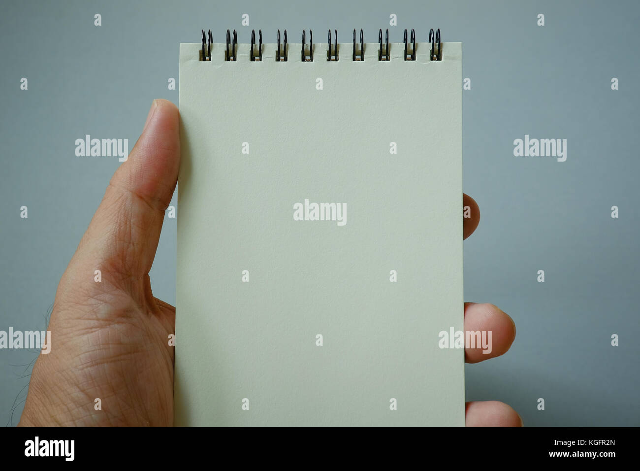 human hand hold spiral notebook Stock Photo - Alamy