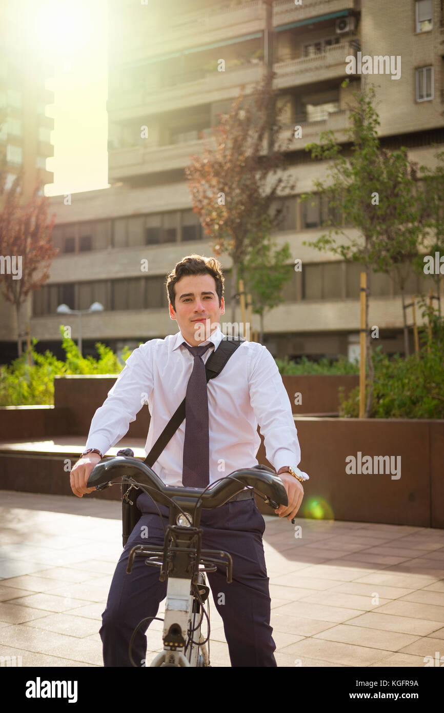 Young businessman riding a bike to work in the city Stock Photo - Alamy
