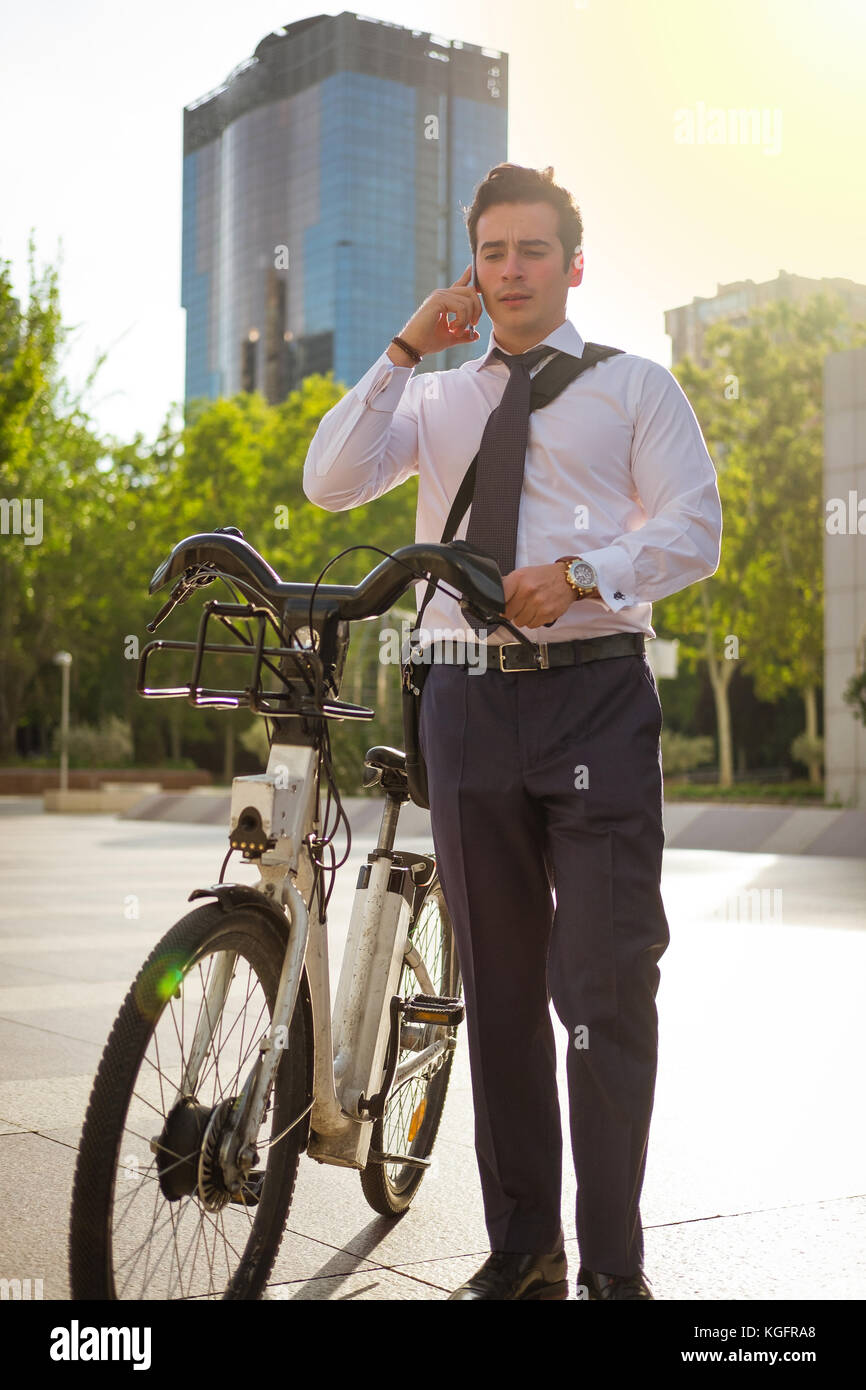 Young businessman riding a bike to work in the city Stock Photo - Alamy