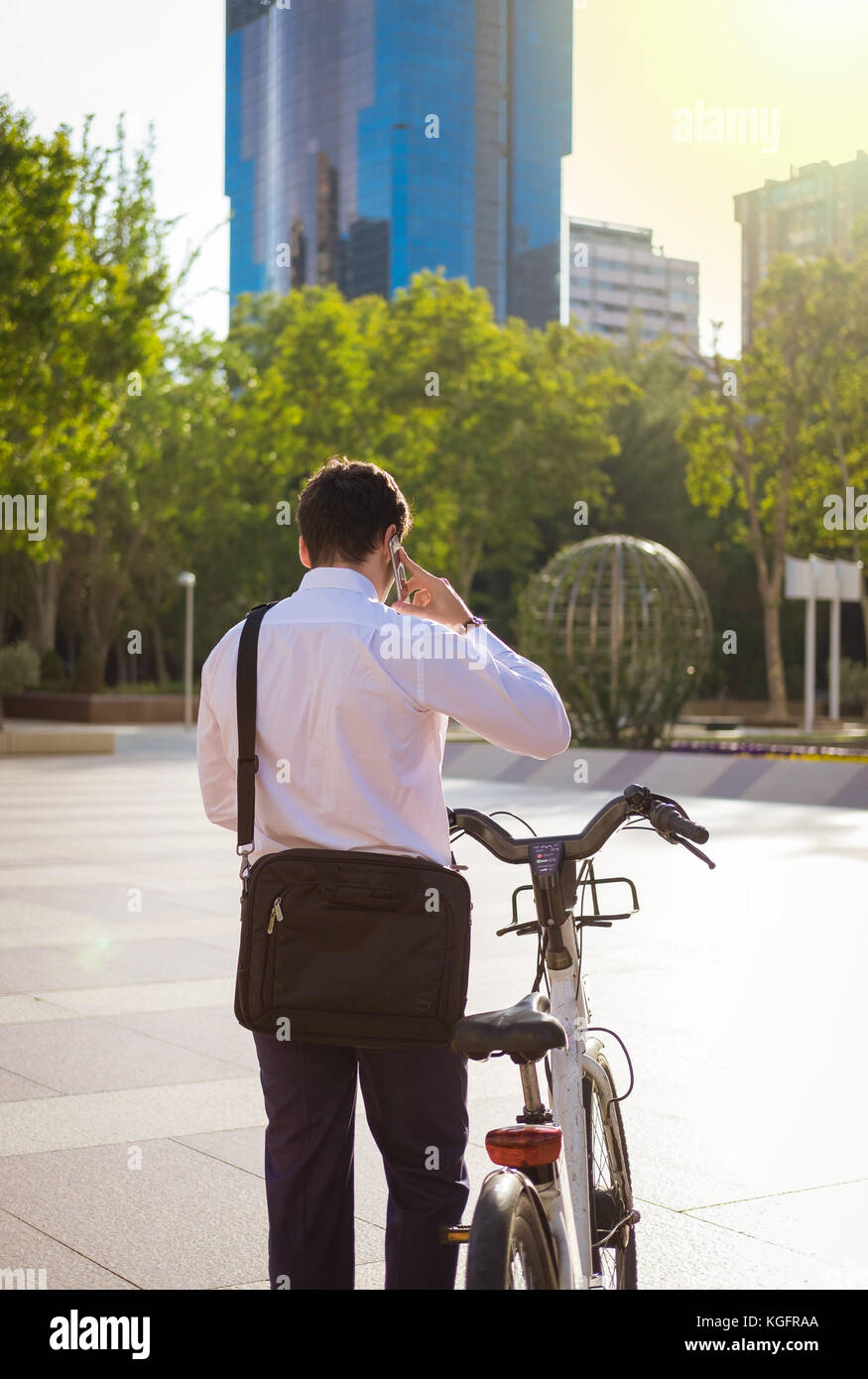 Young businessman riding a bike to work in the city Stock Photo - Alamy