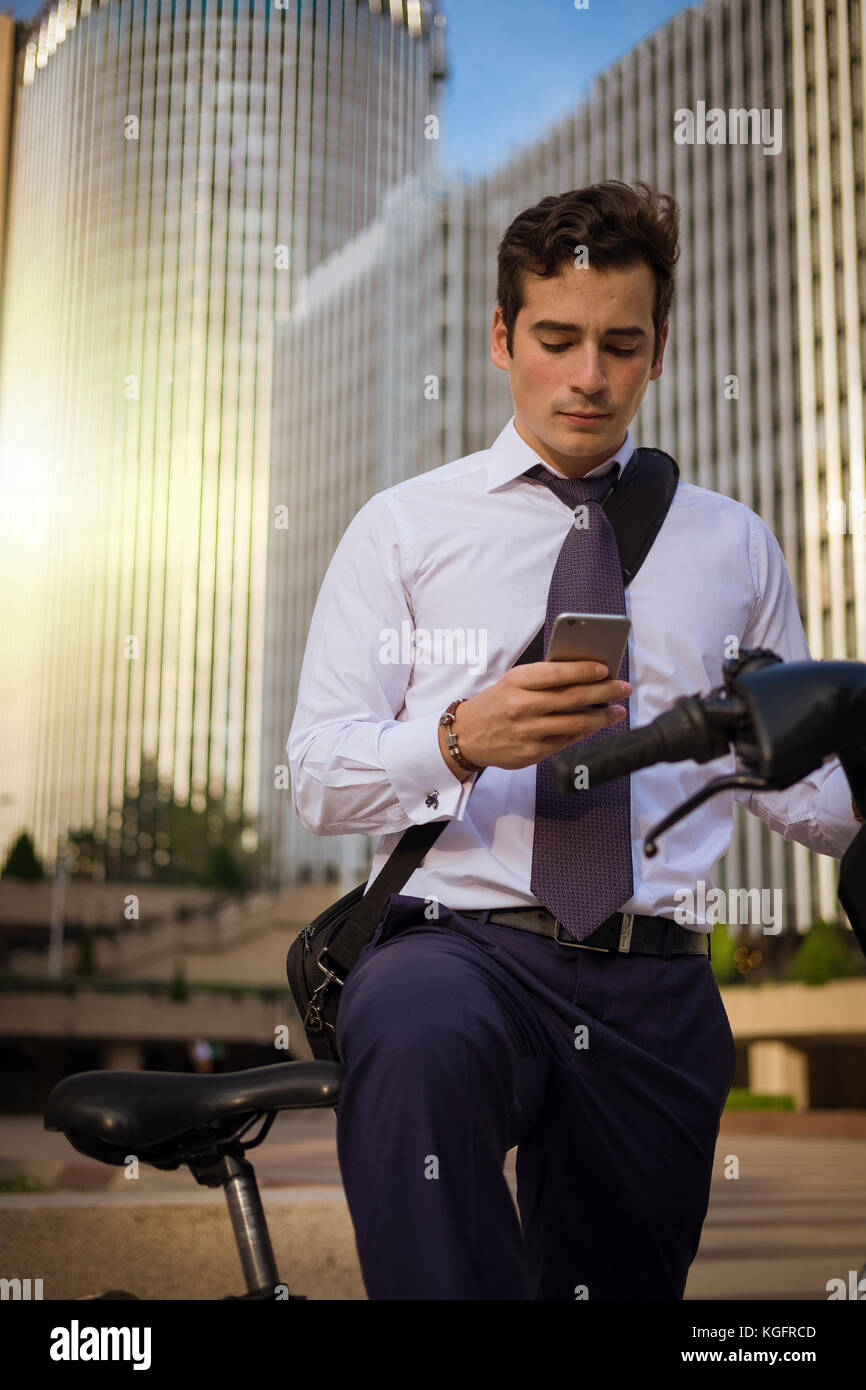 Young businessman riding a bike to work in the city Stock Photo - Alamy