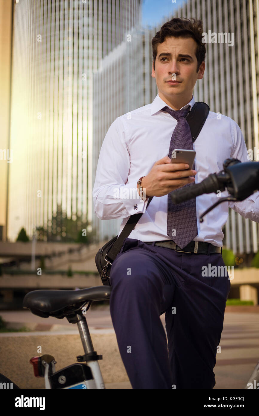 Young businessman riding a bike to work in the city Stock Photo - Alamy