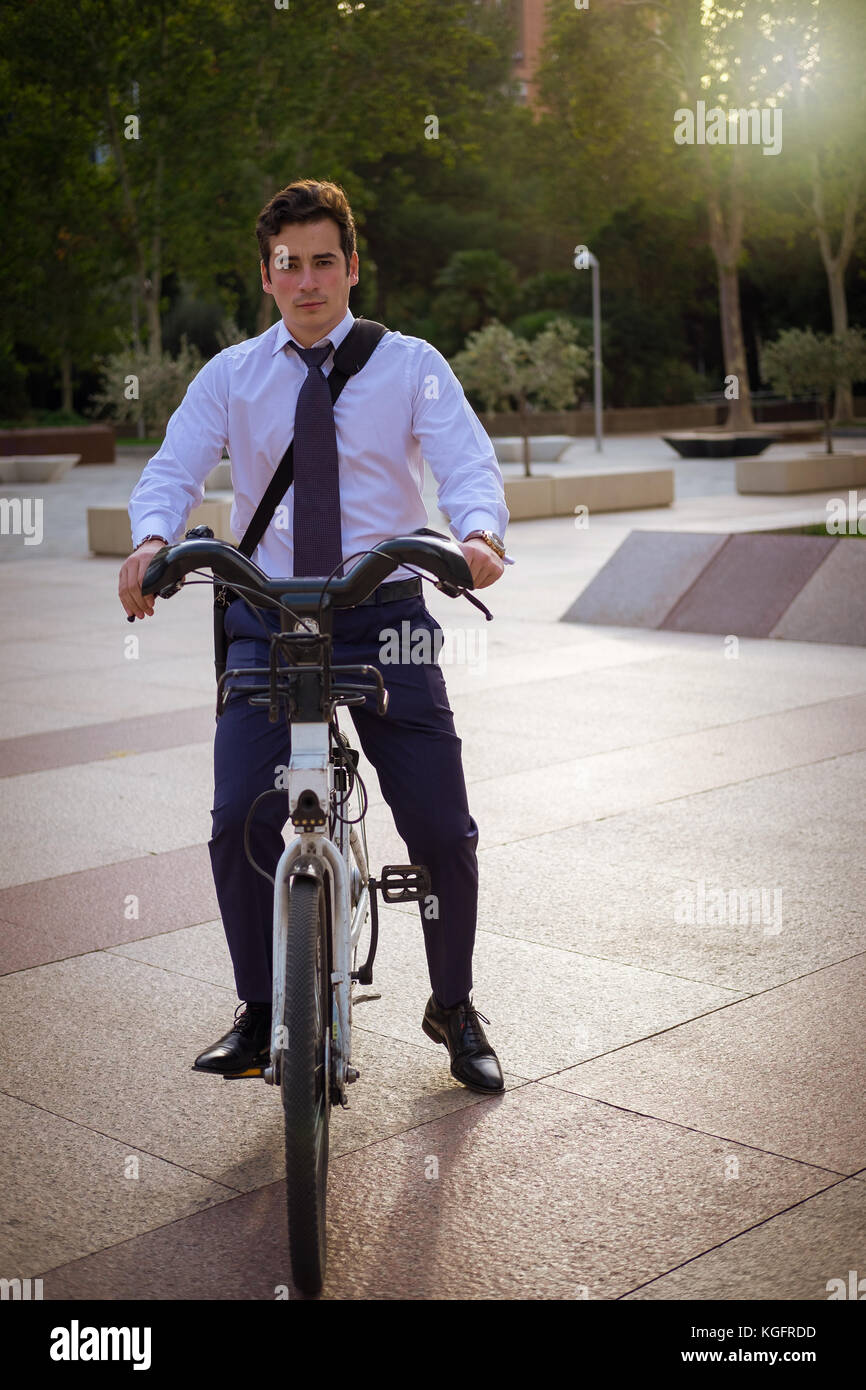 Young businessman riding a bike to work in the city Stock Photo - Alamy