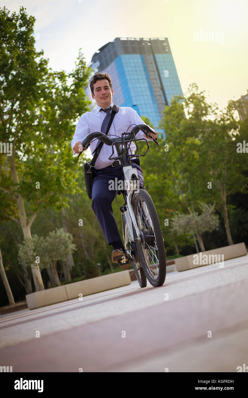 Young businessman riding a bike to work in the city Stock Photo - Alamy