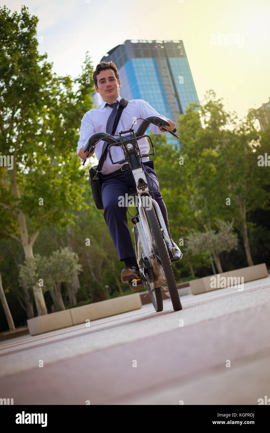 Young businessman riding a bike to work in the city Stock Photo - Alamy