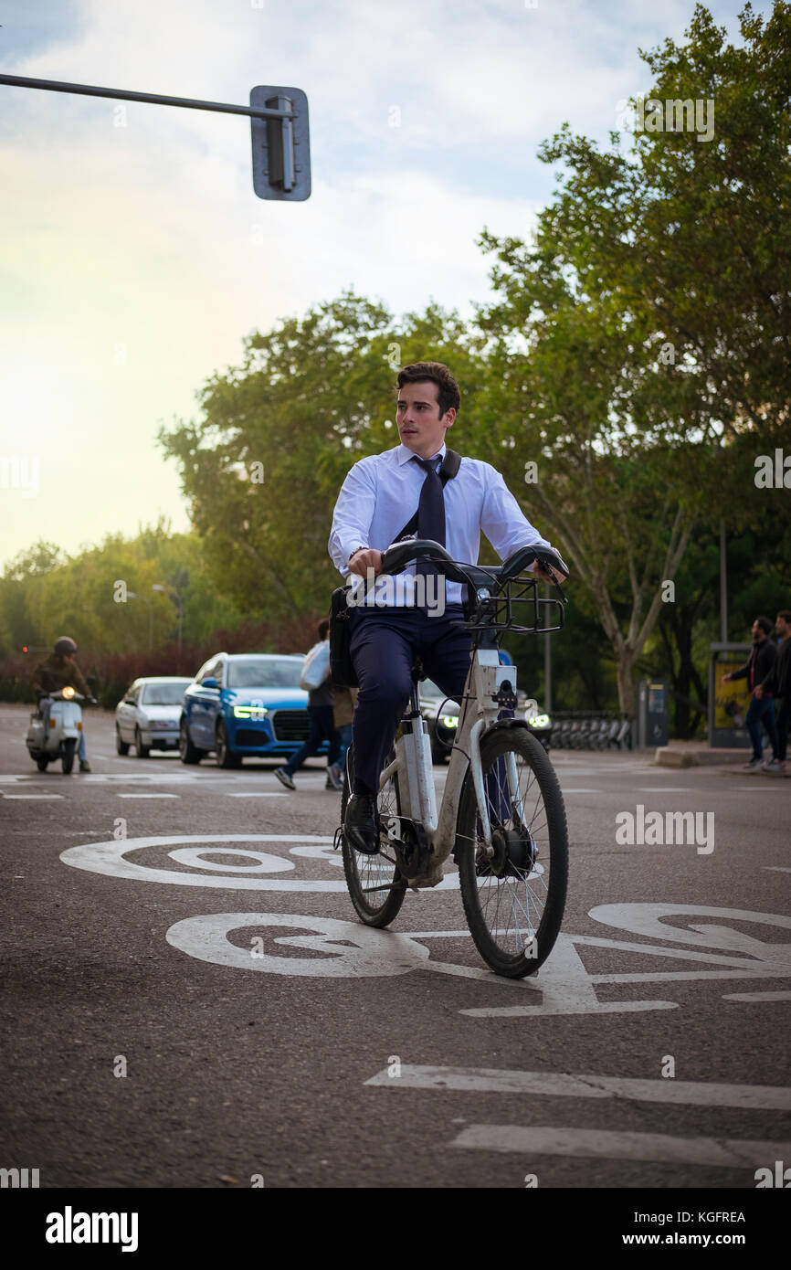 Young businessman riding a bike to work in the city Stock Photo - Alamy