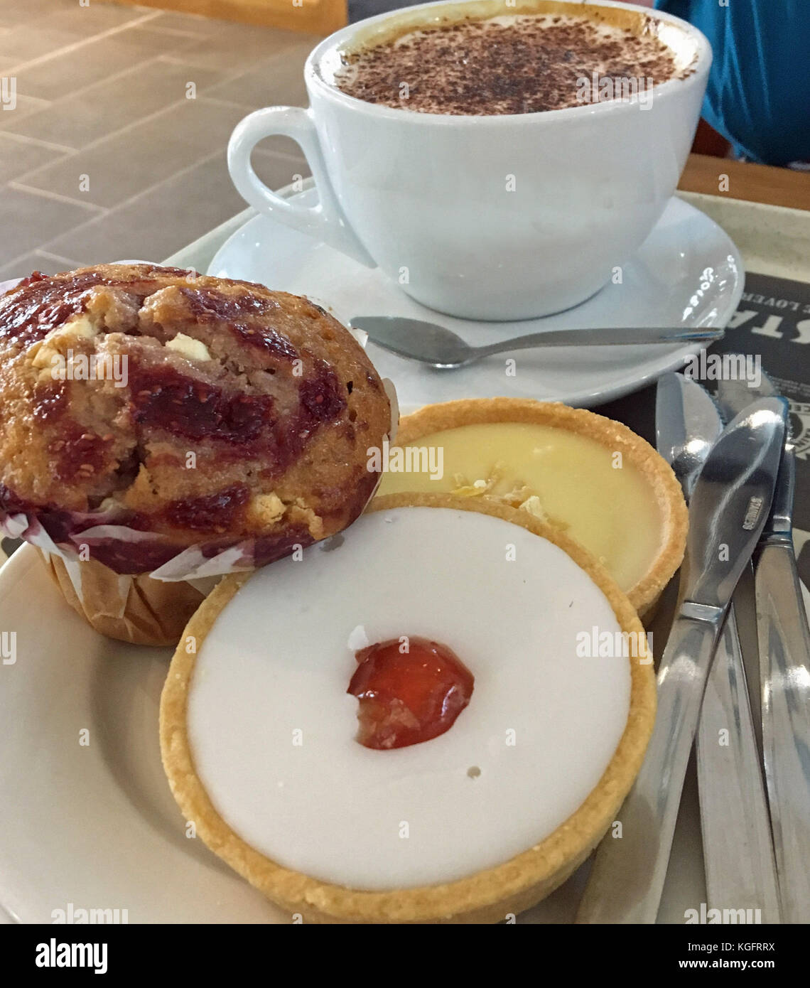 Coffee and a selection of tartlets Stock Photo - Alamy