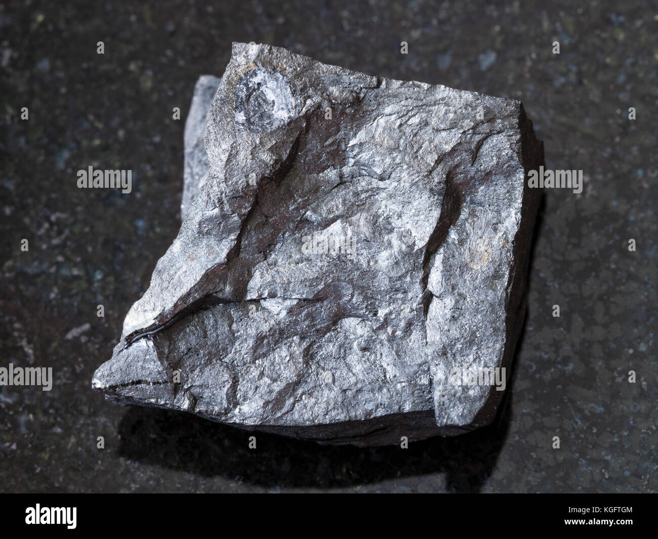 macro shooting of natural mineral rock specimen - raw carbonaceous ...