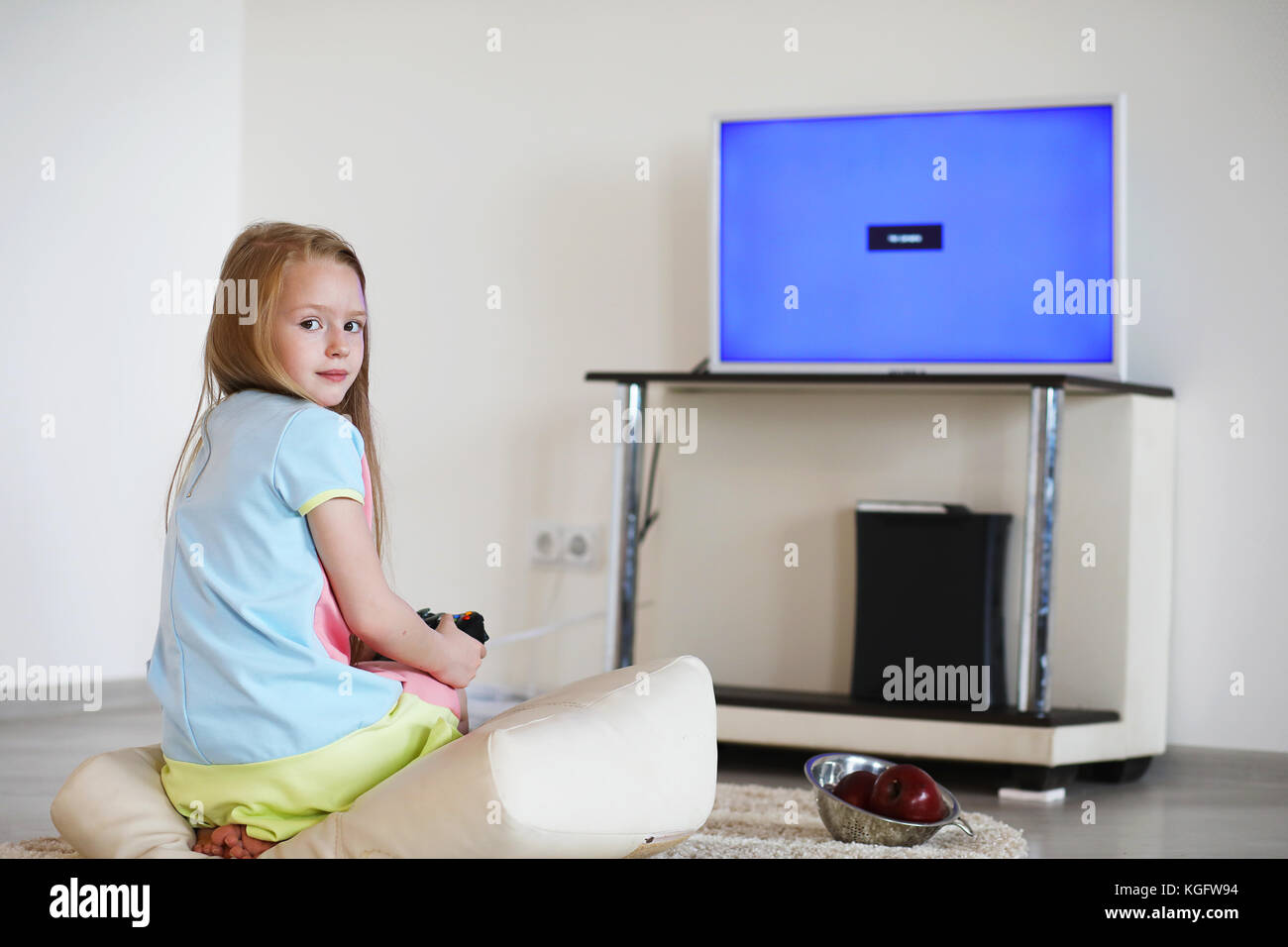 Young girl playing in front of the TV Stock Photo - Alamy