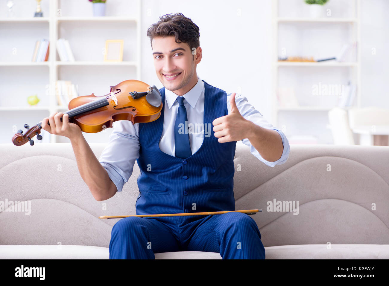 Young musician man practicing playing violin at home Stock Photo - Alamy