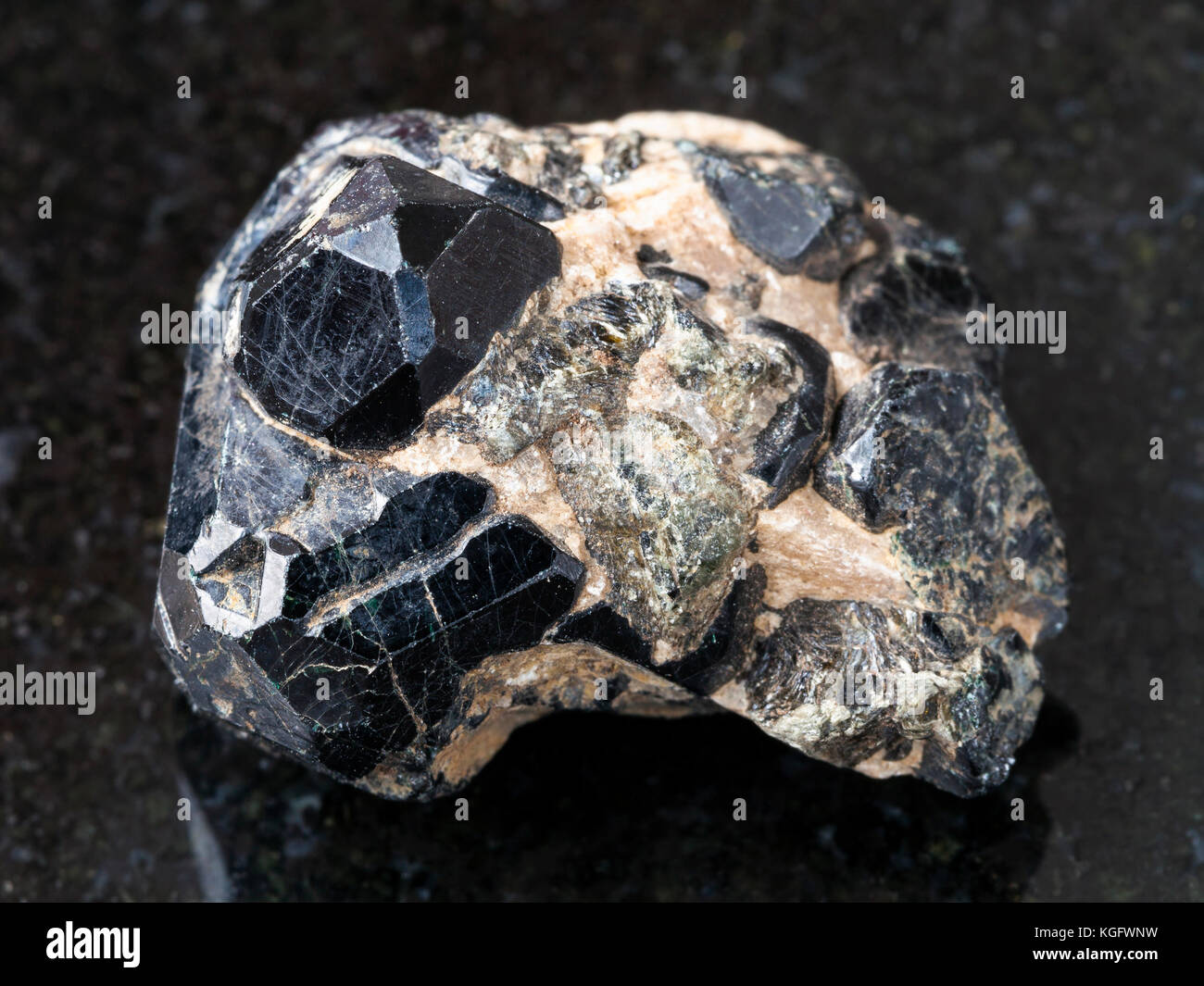 macro shooting of natural mineral rock specimen - raw black crystal of ...