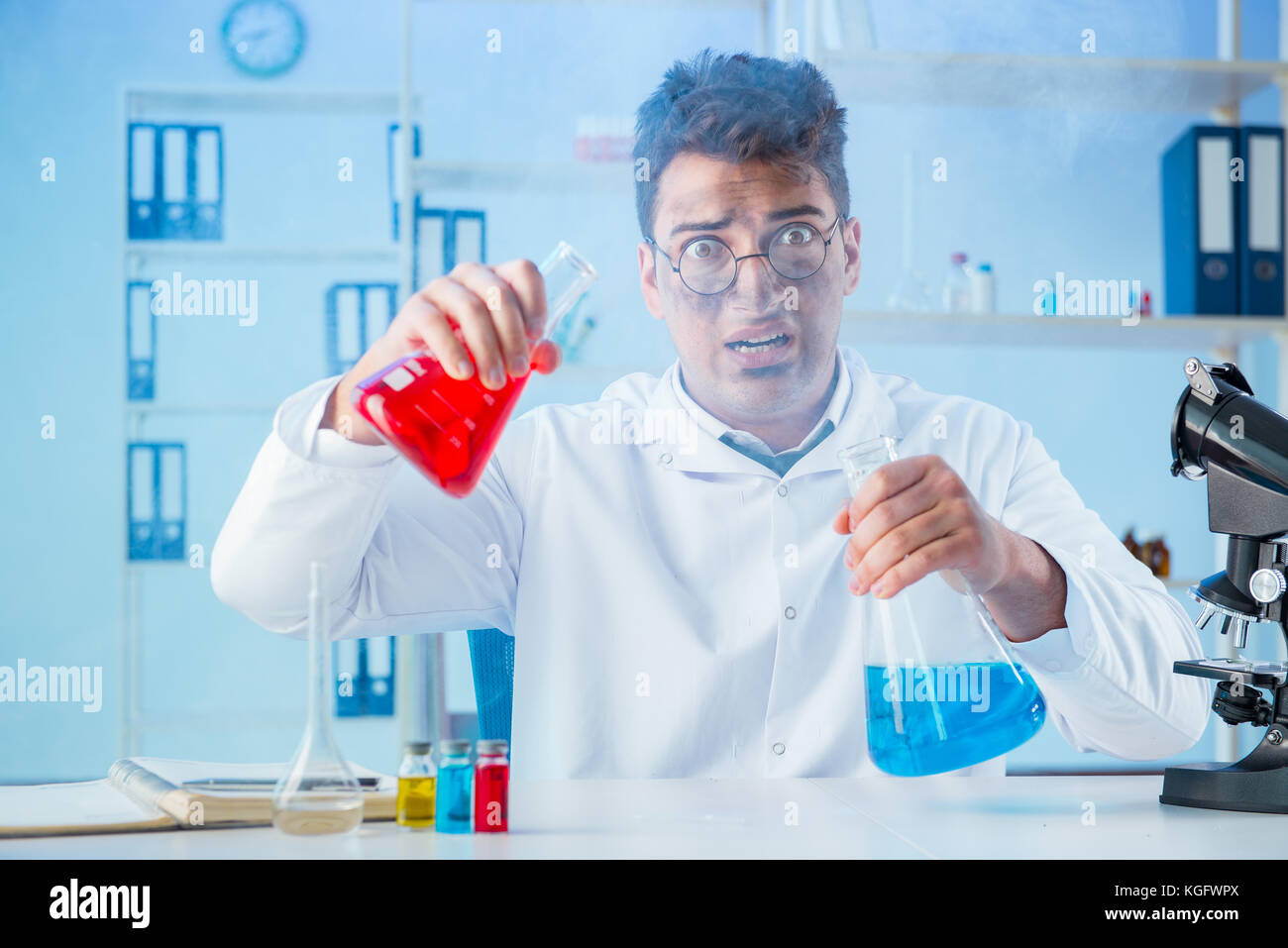 Funny mad chemist working in a laboratory Stock Photo - Alamy