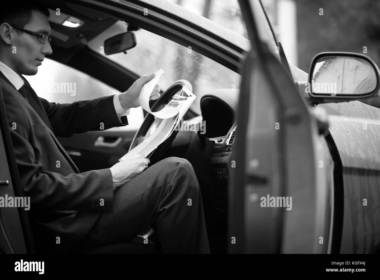 Businessman in a suit in a car Stock Photo - Alamy