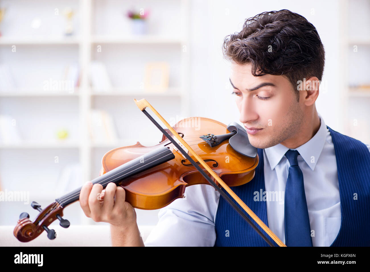 Young musician man practicing playing violin at home Stock Photo - Alamy