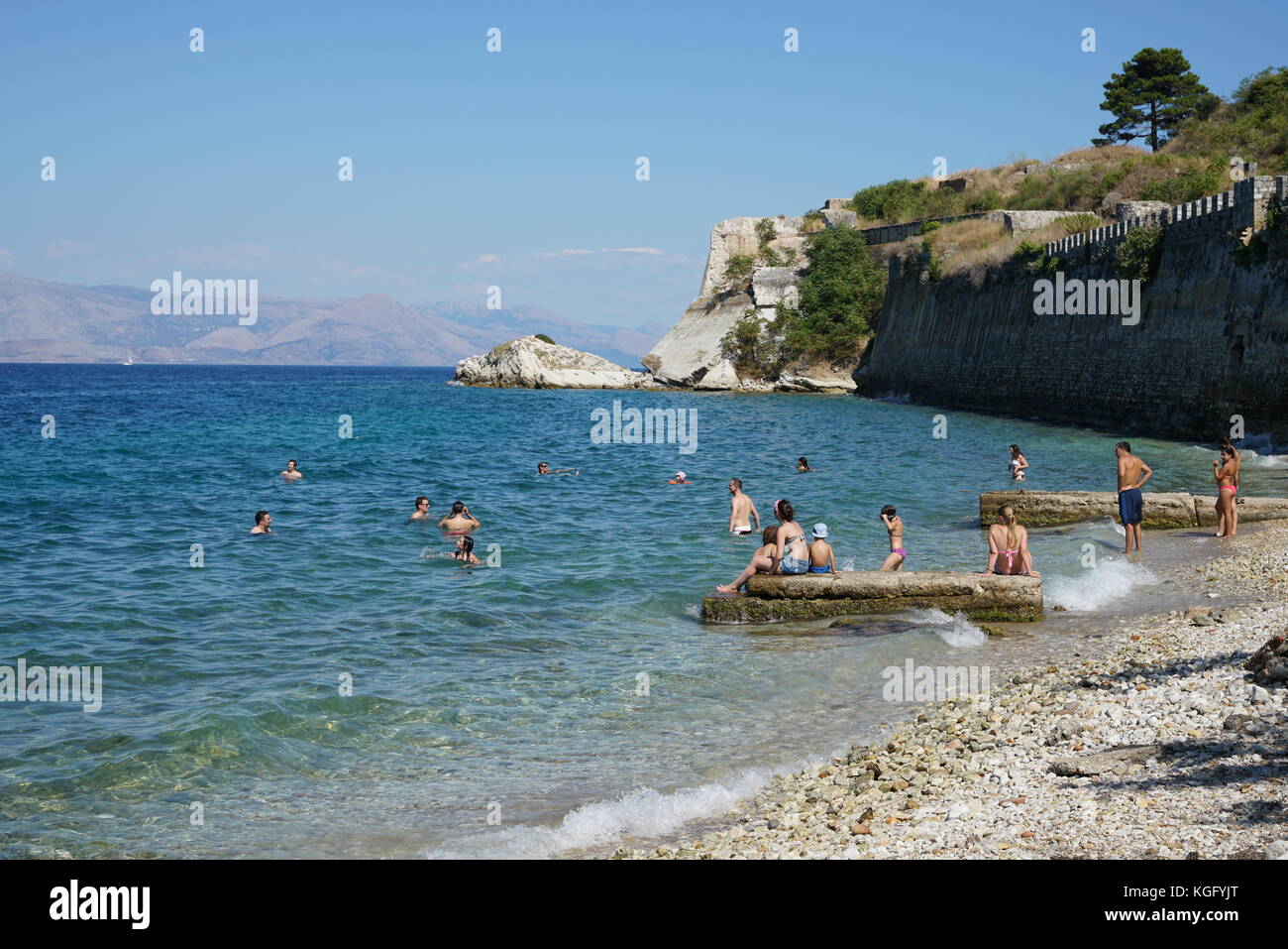 Corfu, Greece: People at the beach swimming and sunbathing Stock Photo ...