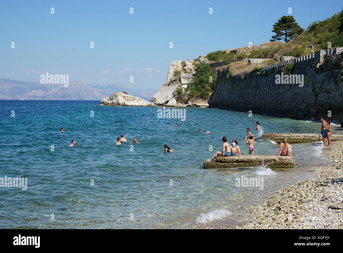 Corfu, Greece: People at the beach swimming and sunbathing Stock Photo ...