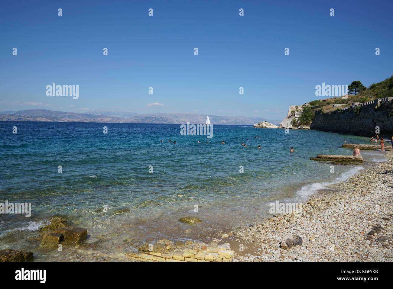 Corfu, Greece: People at the beach swimming and sunbathing Stock Photo ...