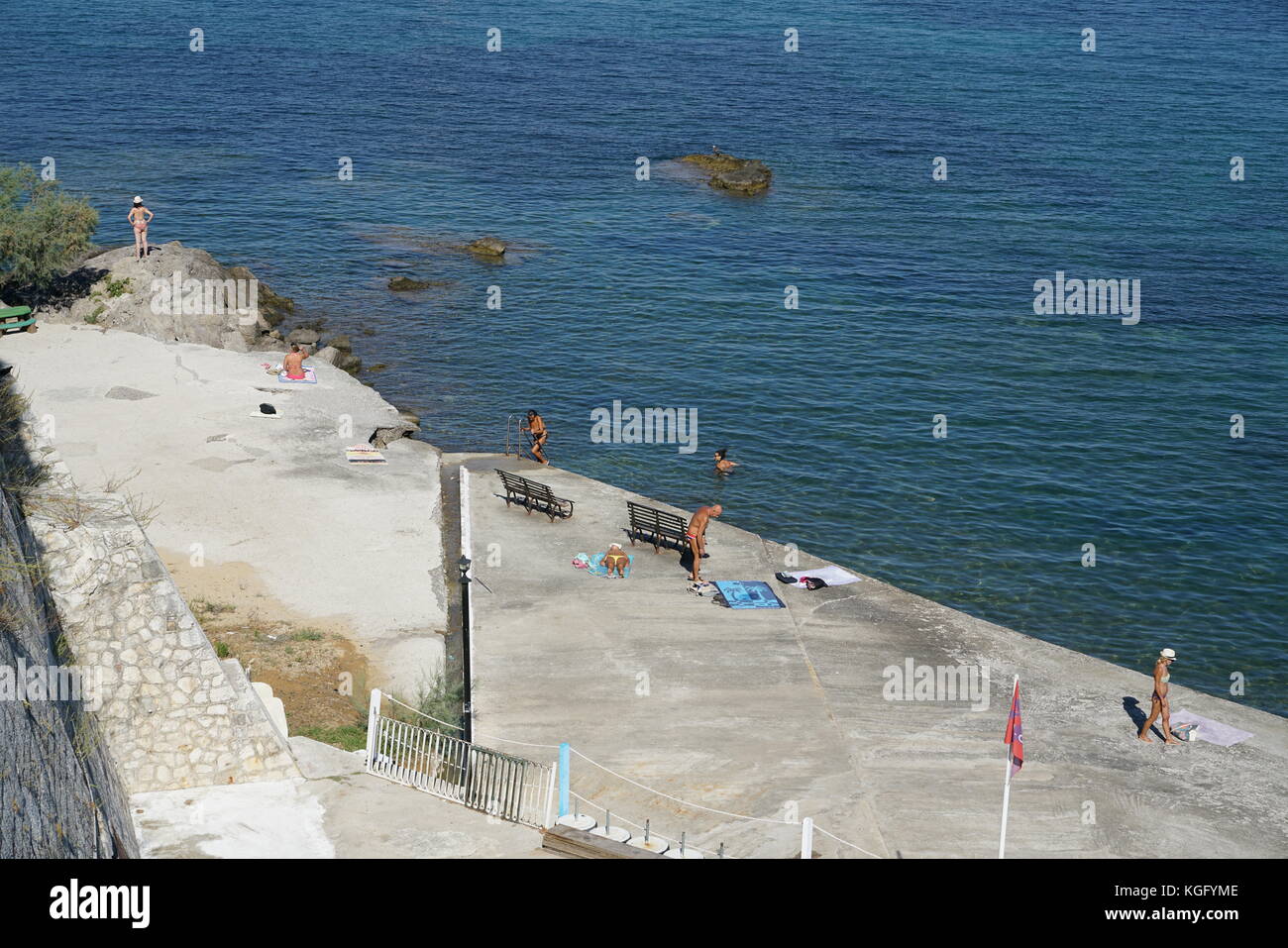 Corfu, Greece: People at the beach swimming and sunbathing Stock Photo ...