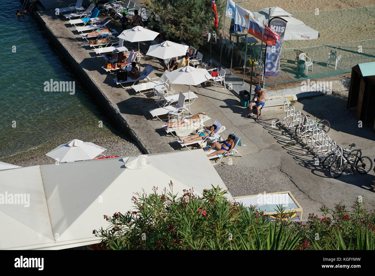 Corfu, Greece: People at the beach swimming and sunbathing Stock Photo ...