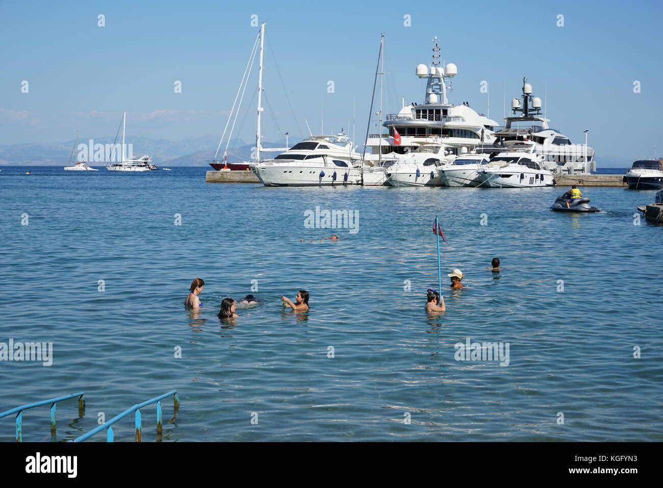 Corfu, Greece: People at the beach swimming and sunbathing Stock Photo ...