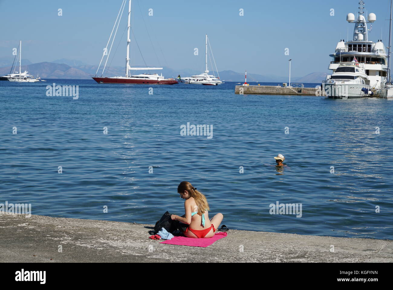 Corfu, Greece: People at the beach swimming and sunbathing Stock Photo ...