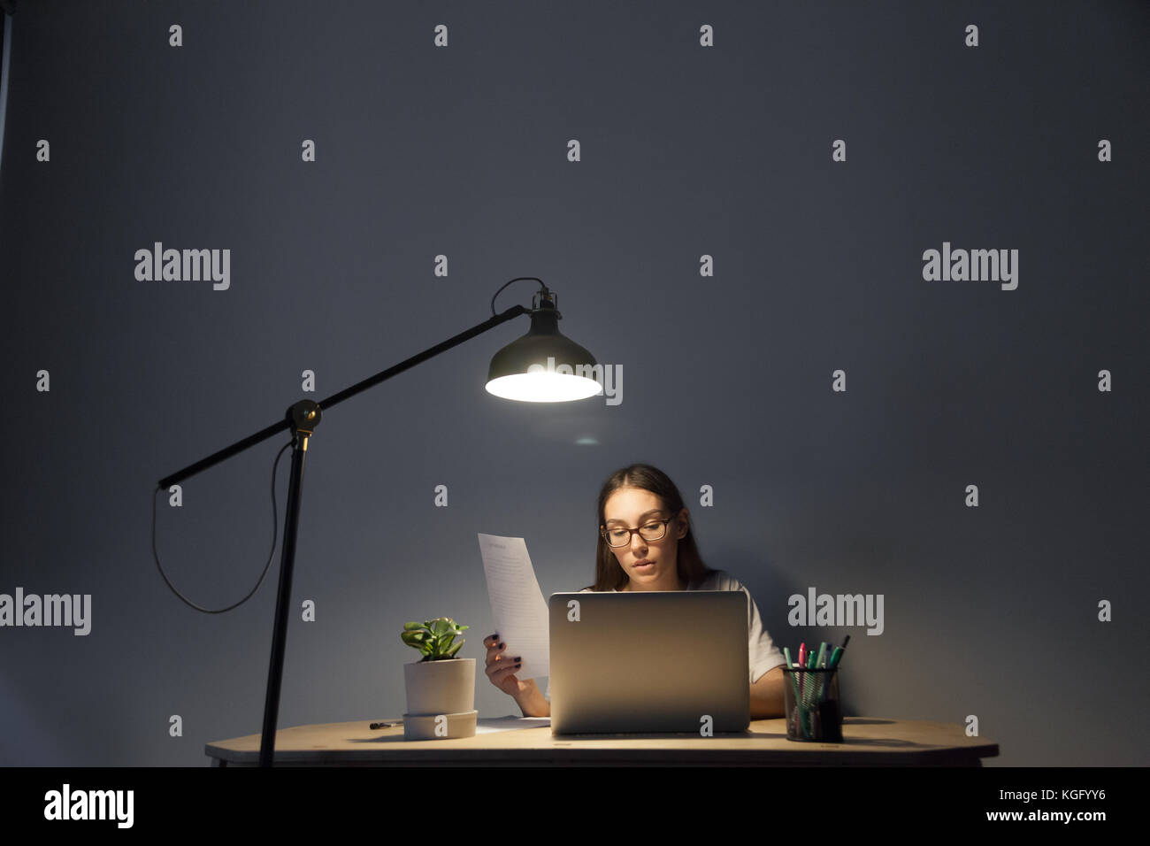 Overworked tired young adult female accountant working on laptop ...