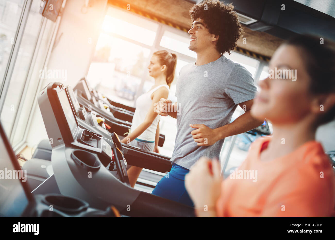 Young handsome man doing cardio training in gym Stock Photo - Alamy
