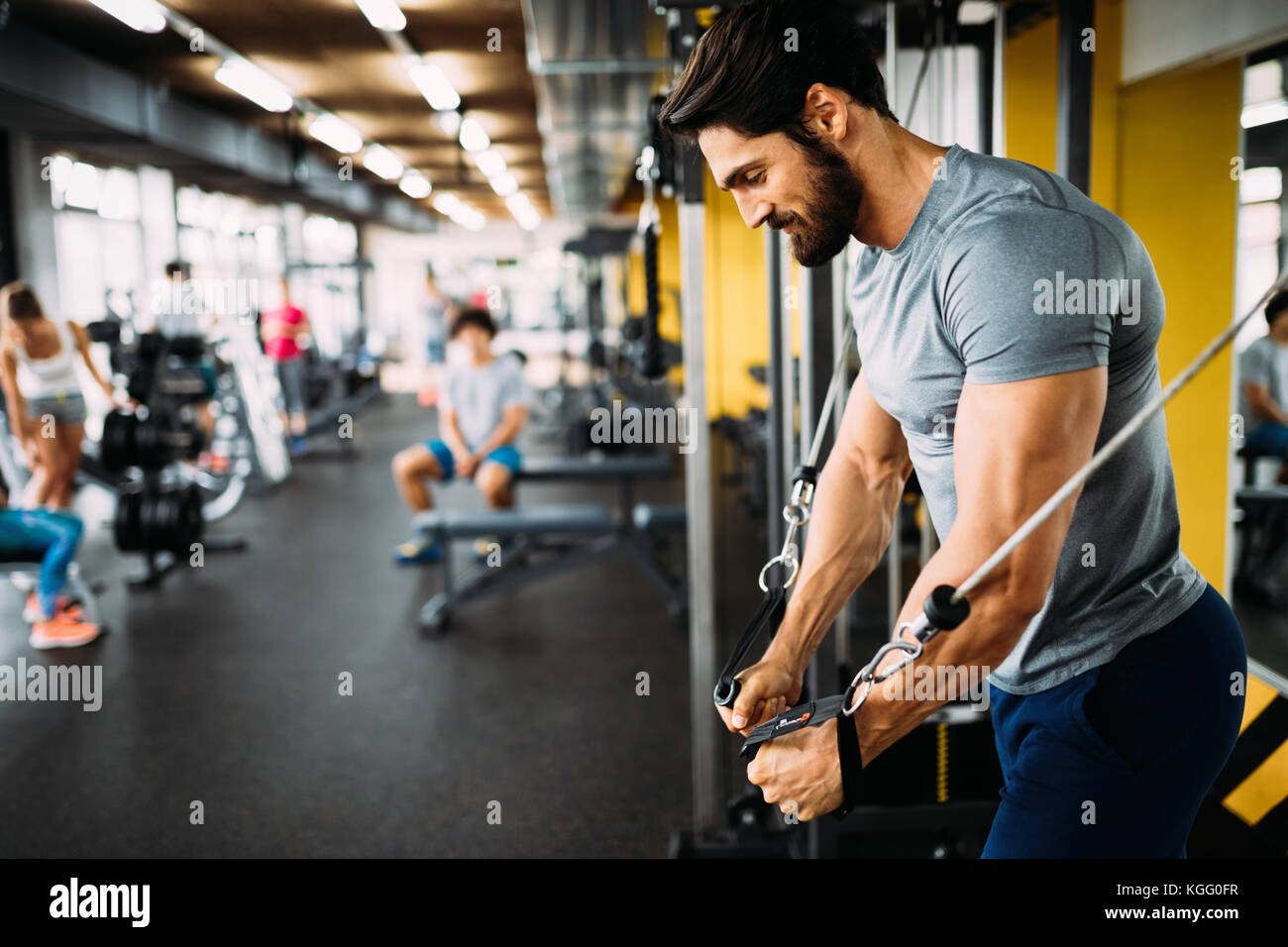 Young handsome man doing exercises in gym Stock Photo - Alamy