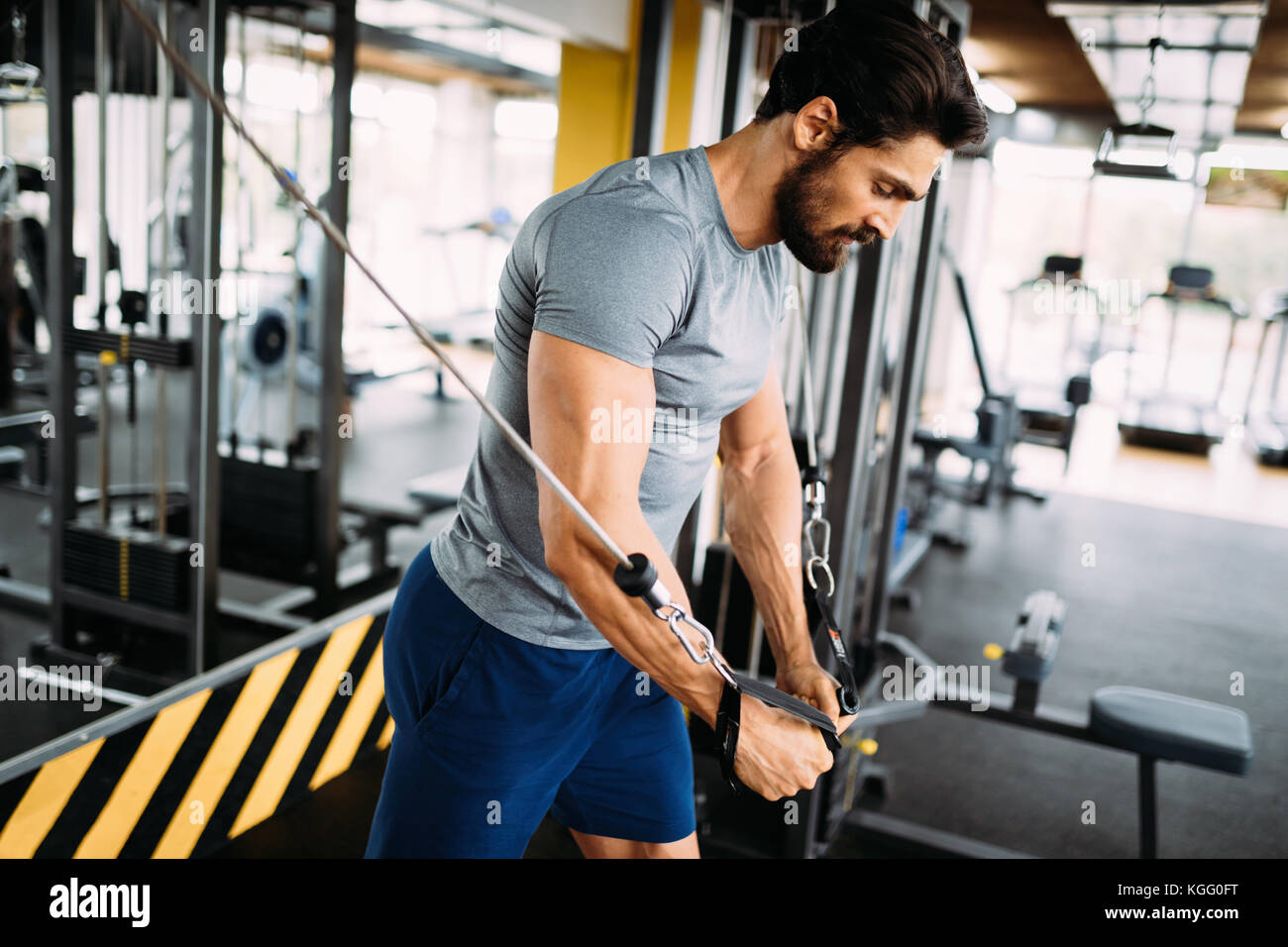 Young handsome man doing exercises in gym Stock Photo - Alamy