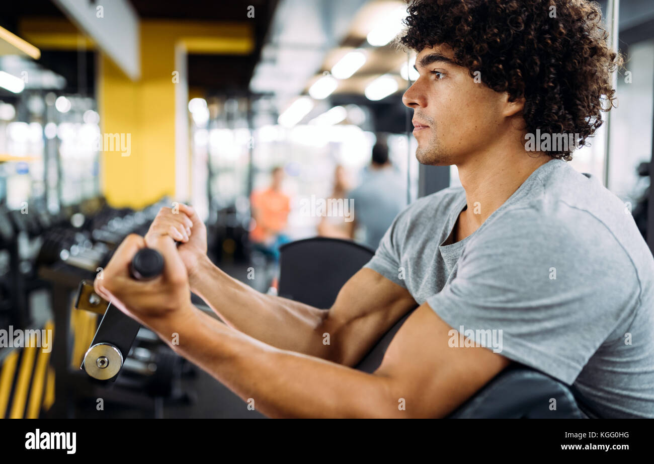 Young handsome man doing exercises in gym Stock Photo - Alamy