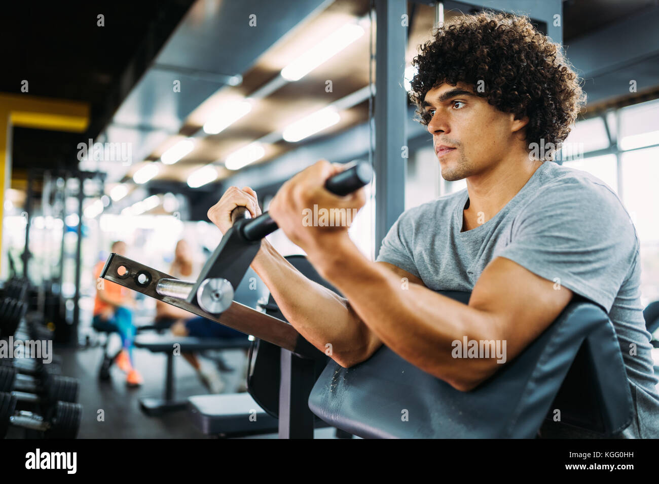 Young handsome man doing exercises in gym Stock Photo - Alamy