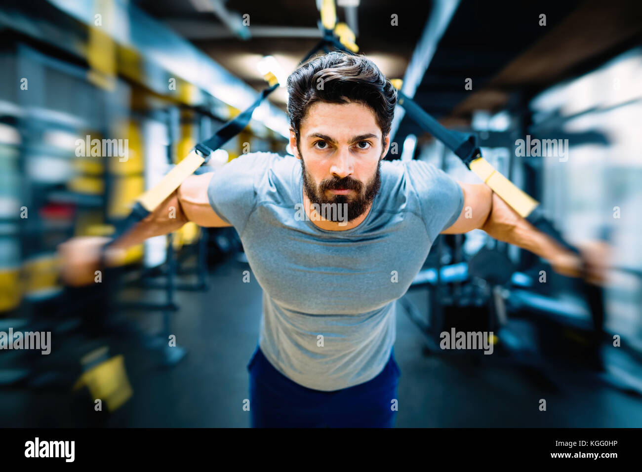 Young handsome man doing exercises in gym Stock Photo - Alamy