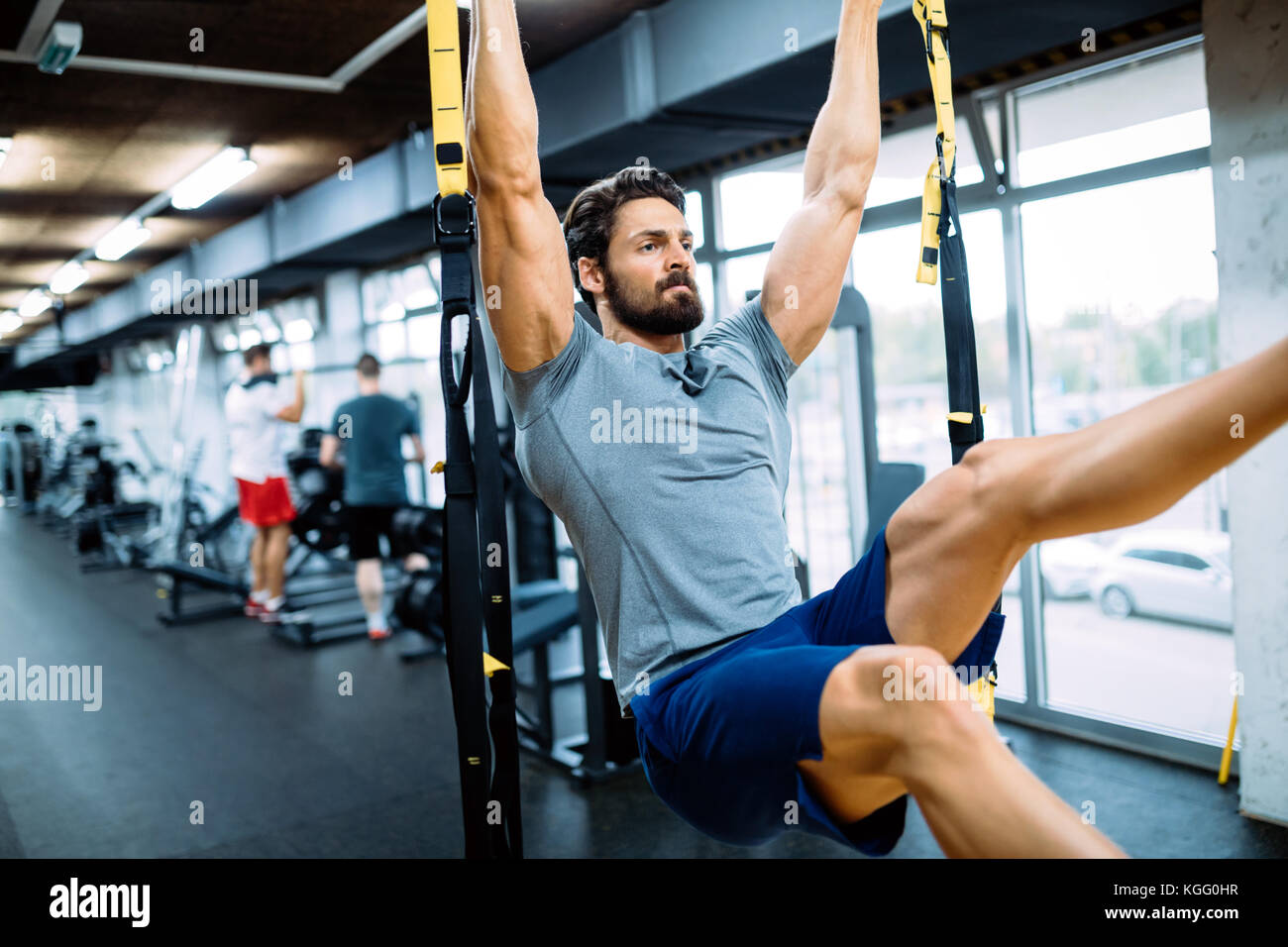 Young handsome man doing exercises in gym Stock Photo - Alamy