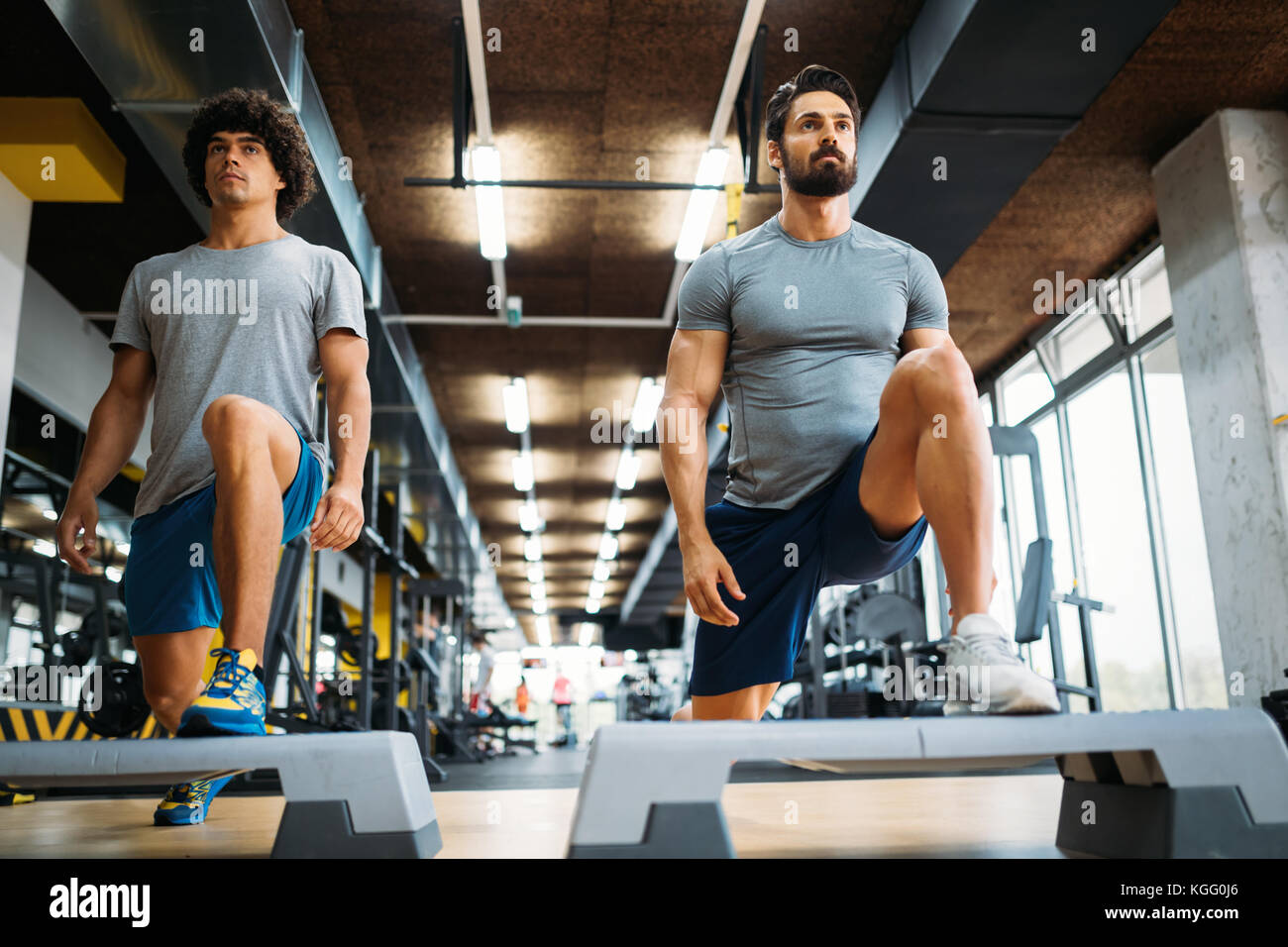 Group of young people doing exercises in gym Stock Photo - Alamy