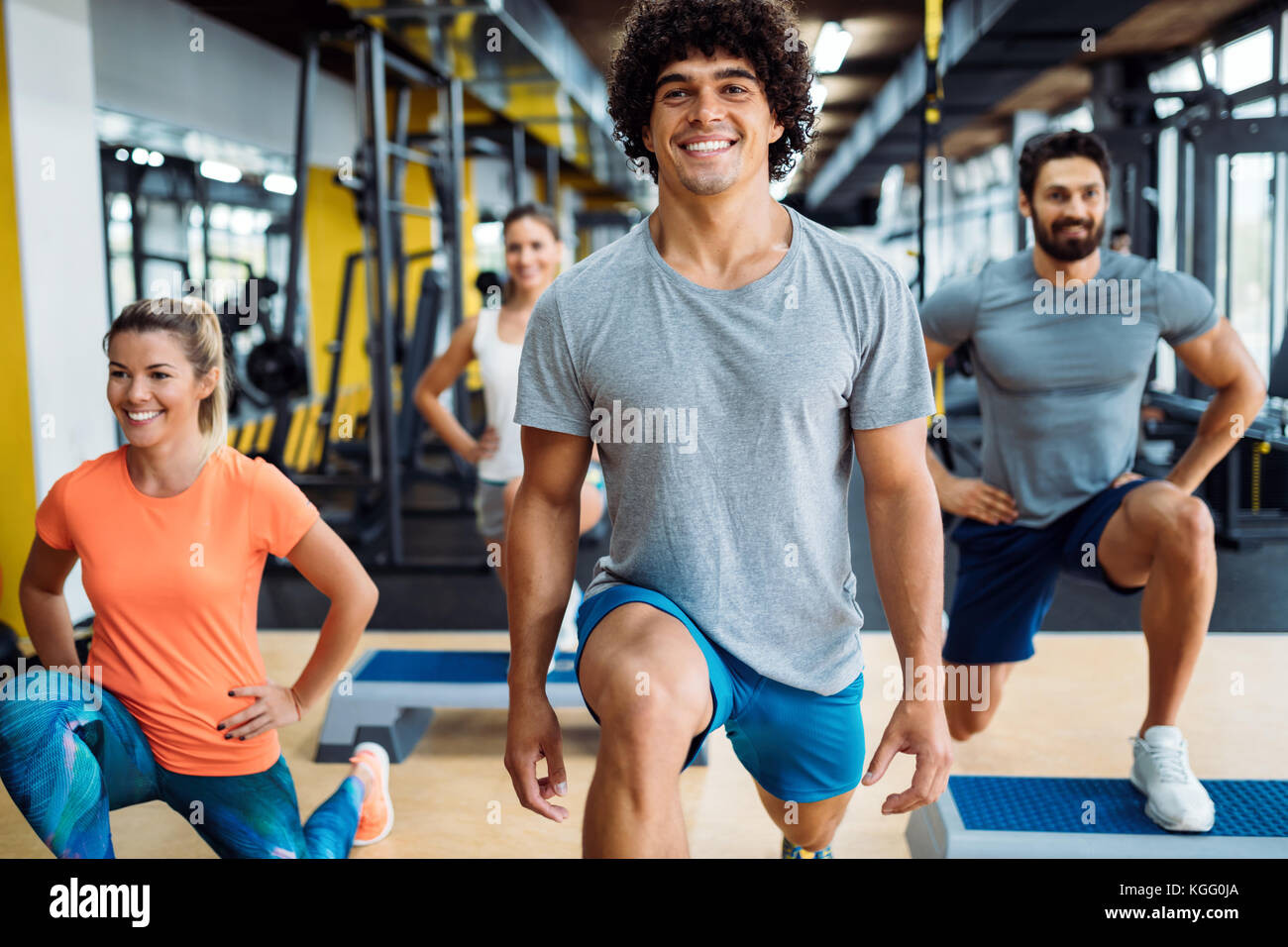 Group of young people doing exercises in gym Stock Photo - Alamy