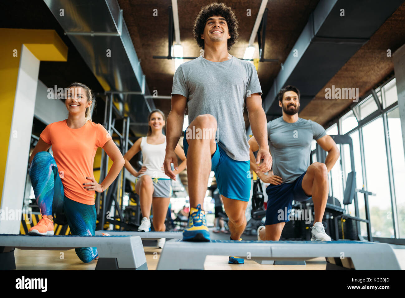 Group of young people doing exercises in gym Stock Photo - Alamy