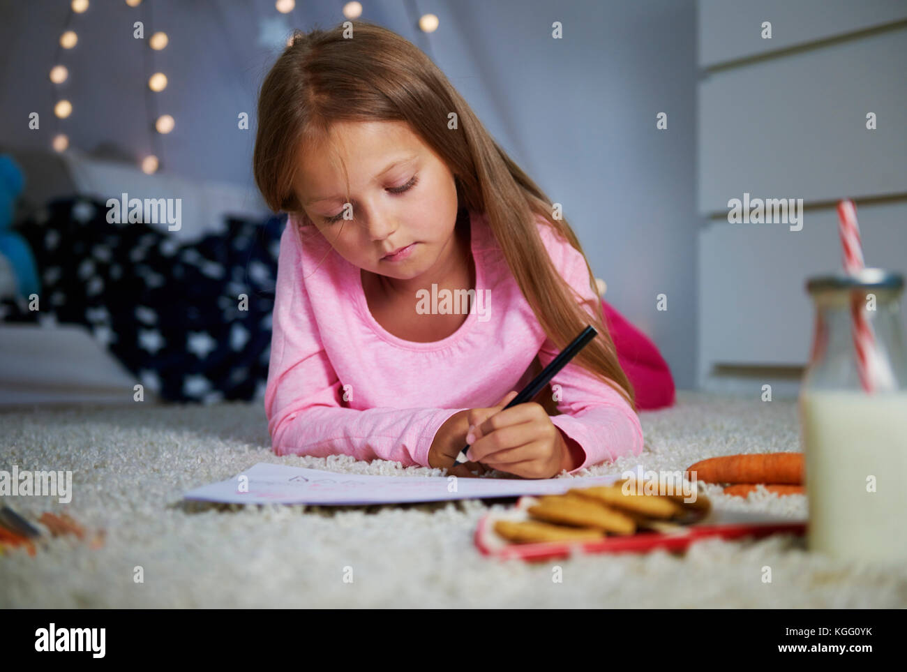 Girl lying on front and writing a letter Stock Photo - Alamy