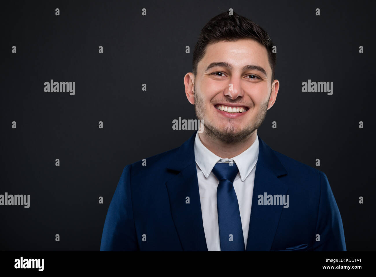 Portrait of young smiling businessman with blue suit and tie isolated ...