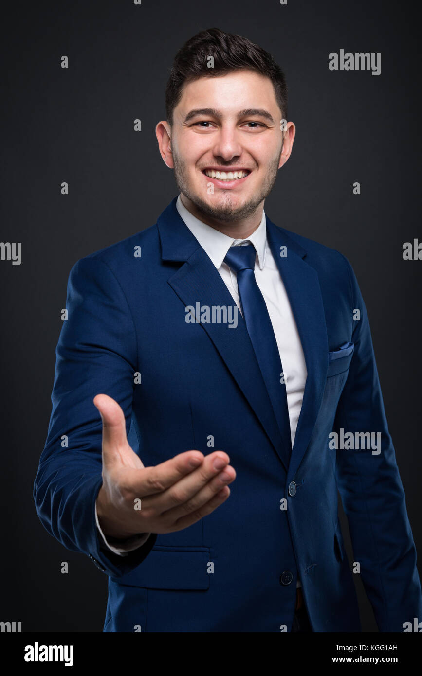 Friendly businessman smiling and being ready to handshake or ...