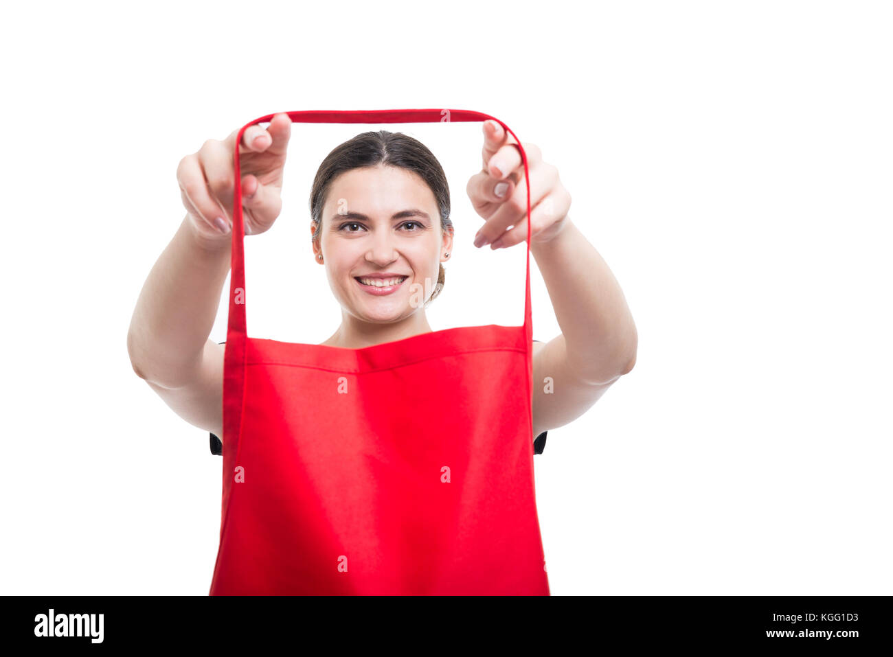Cheerful female seller putting her apron on getting ready for work on ...