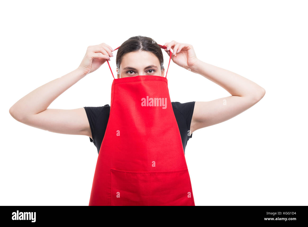Happy young clerk wearing a red apron at her supermarket job isolated ...