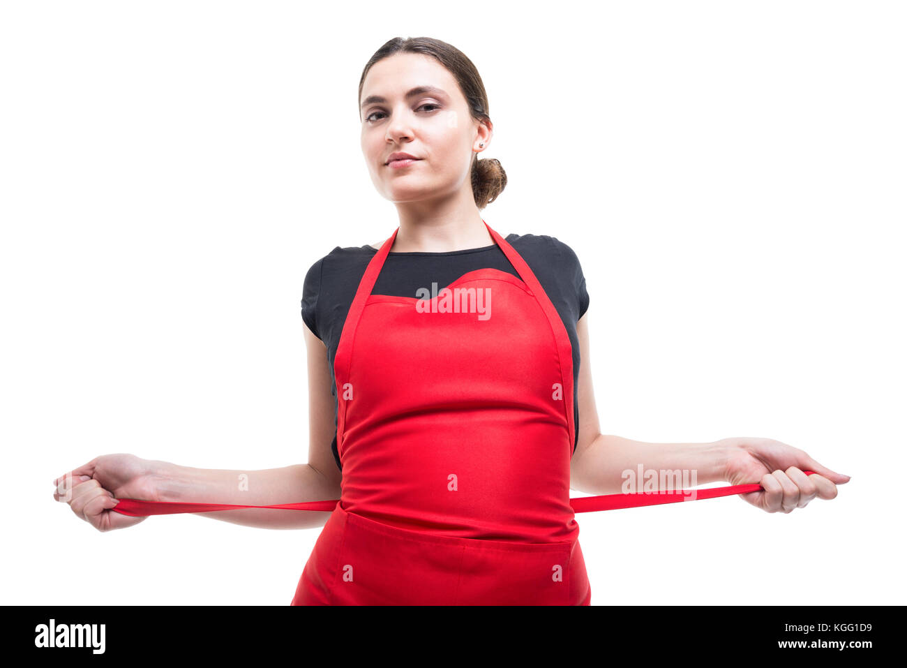 Attractive female merchandiser preparing for work and tying her apron ...